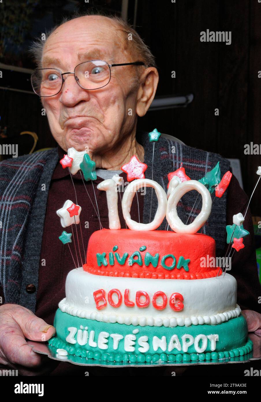 An elderley man on his 100th birthday cake Stock Photo - Alamy