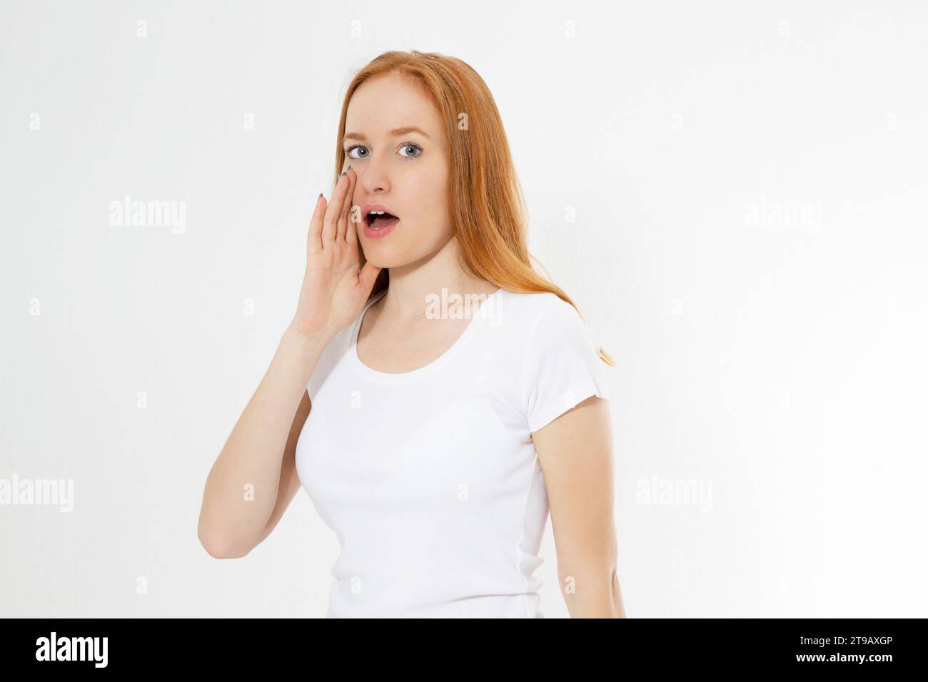 Young woman telling something, red head girl telling a secret. Portrait ...