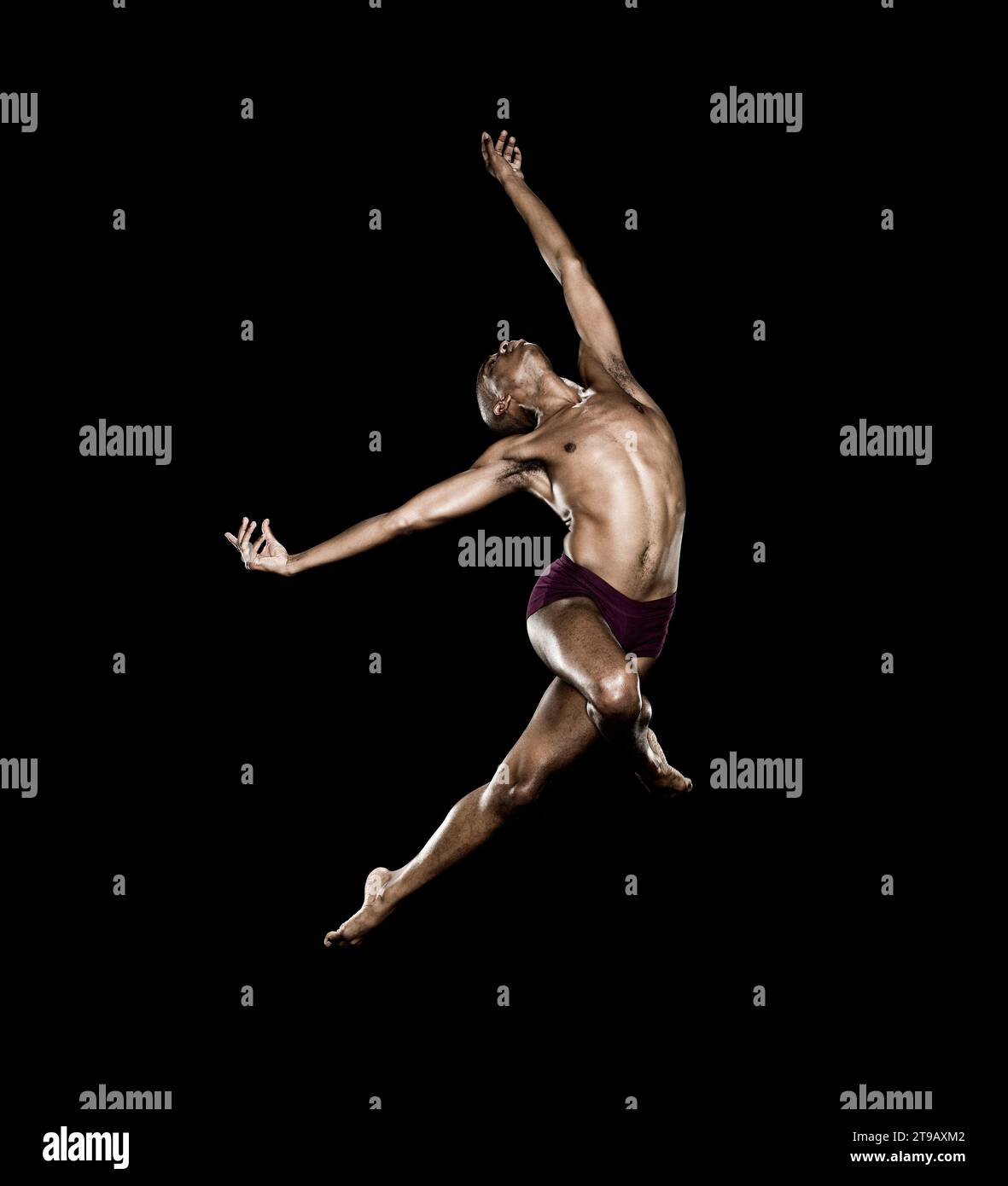 A dancer performing beautiful body controlled jumps with help from a ...
