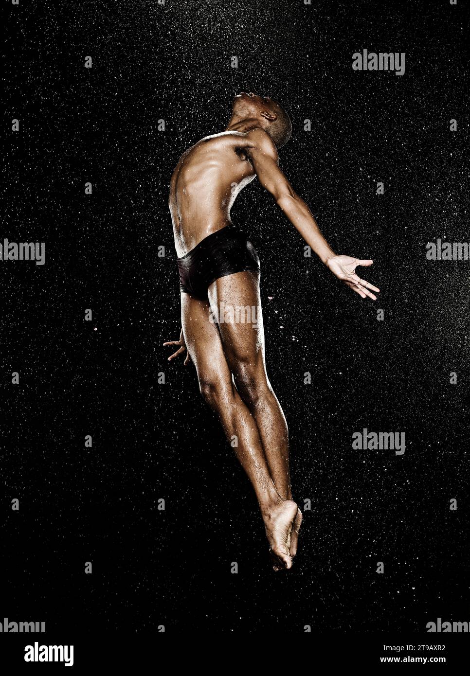 A dancer performing beautiful body controlled jumps with help from a ...