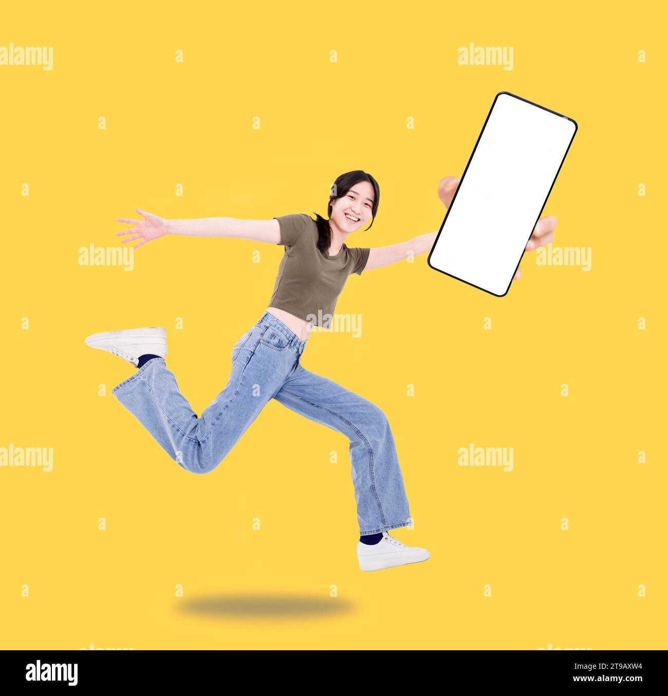 Happy girl student showing the blank screen mobile phone jump and run ...