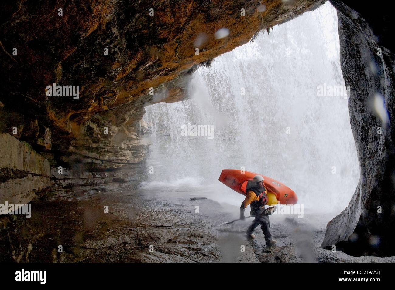 Attractive male kayaker standing underneath a waterfall Stock Photo - Alamy