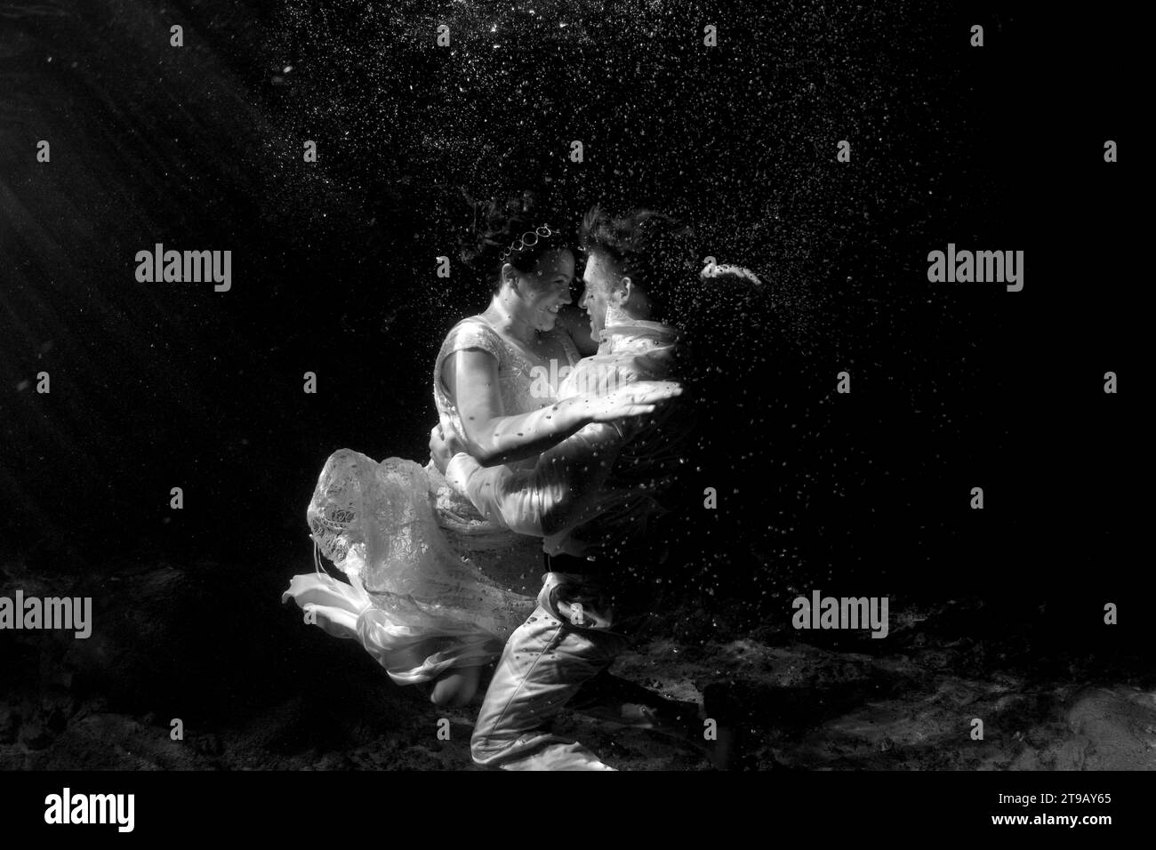 Black and white underwater image of a man and woman swimming and ...