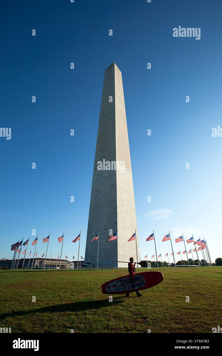 One man walking by a national memorial in nice light with a stand up ...