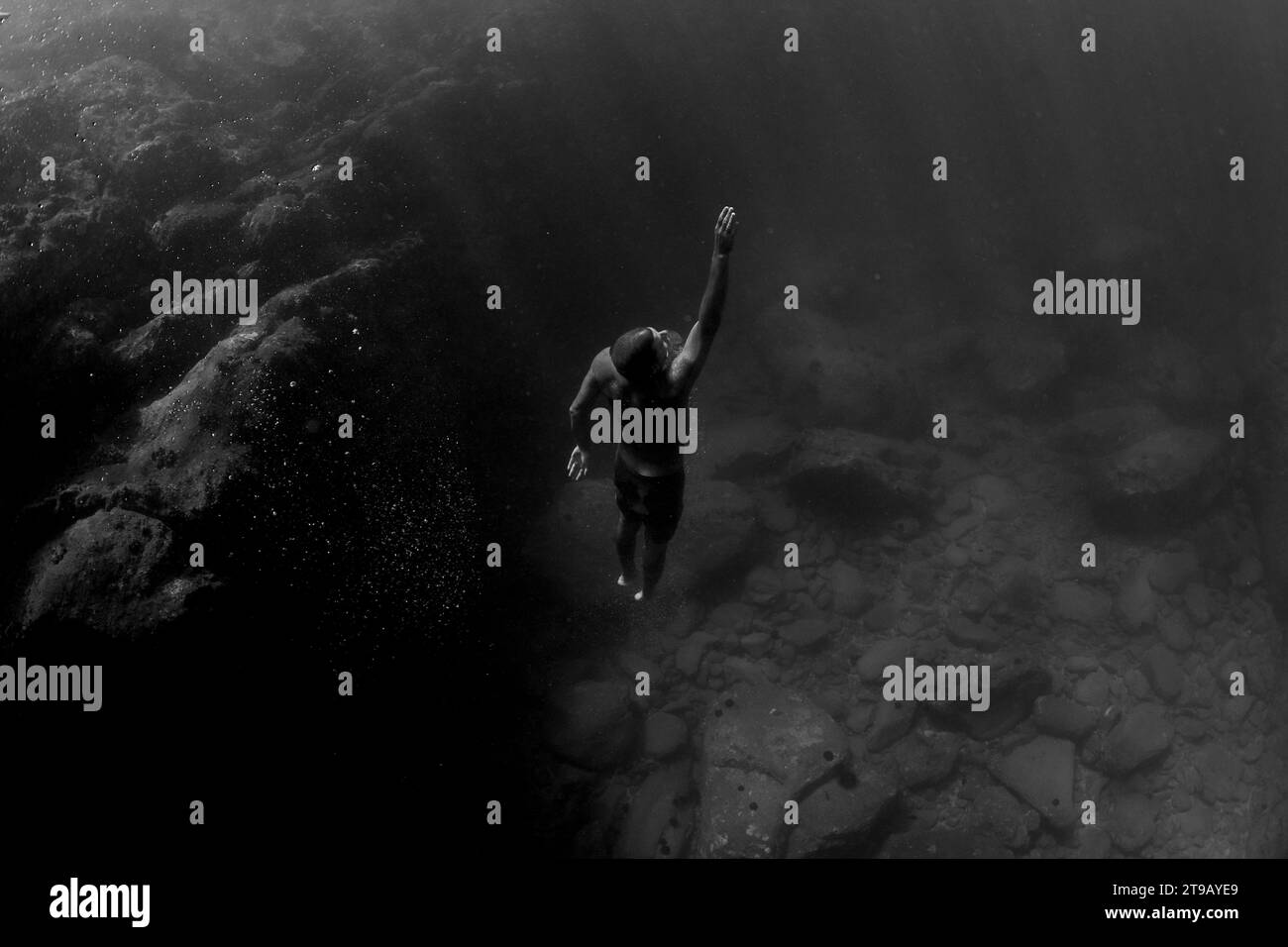Underwater perspective of a man swimming near cliffs Stock Photo - Alamy