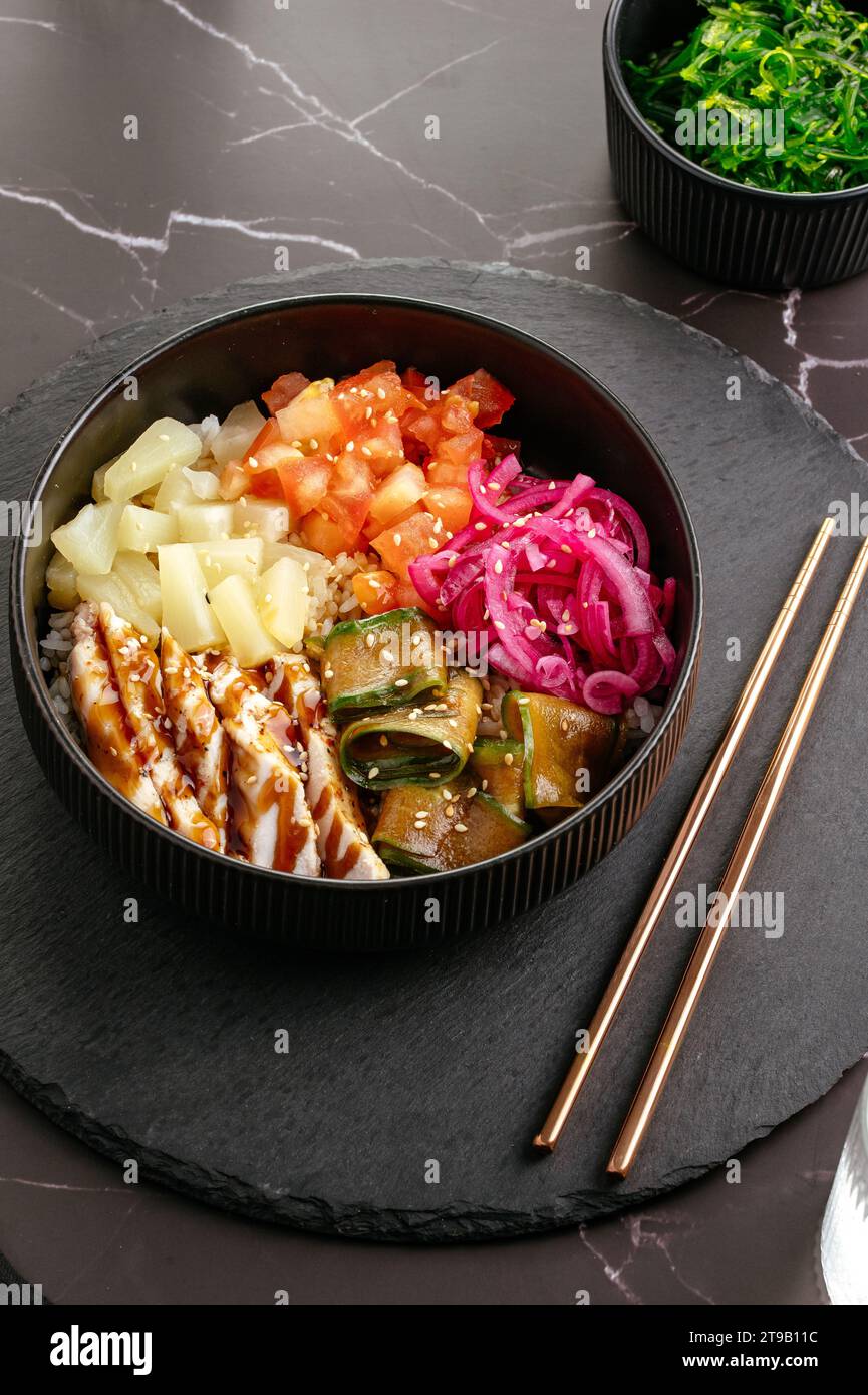 Hawaiian chicken poke bowl with rice Stock Photo - Alamy