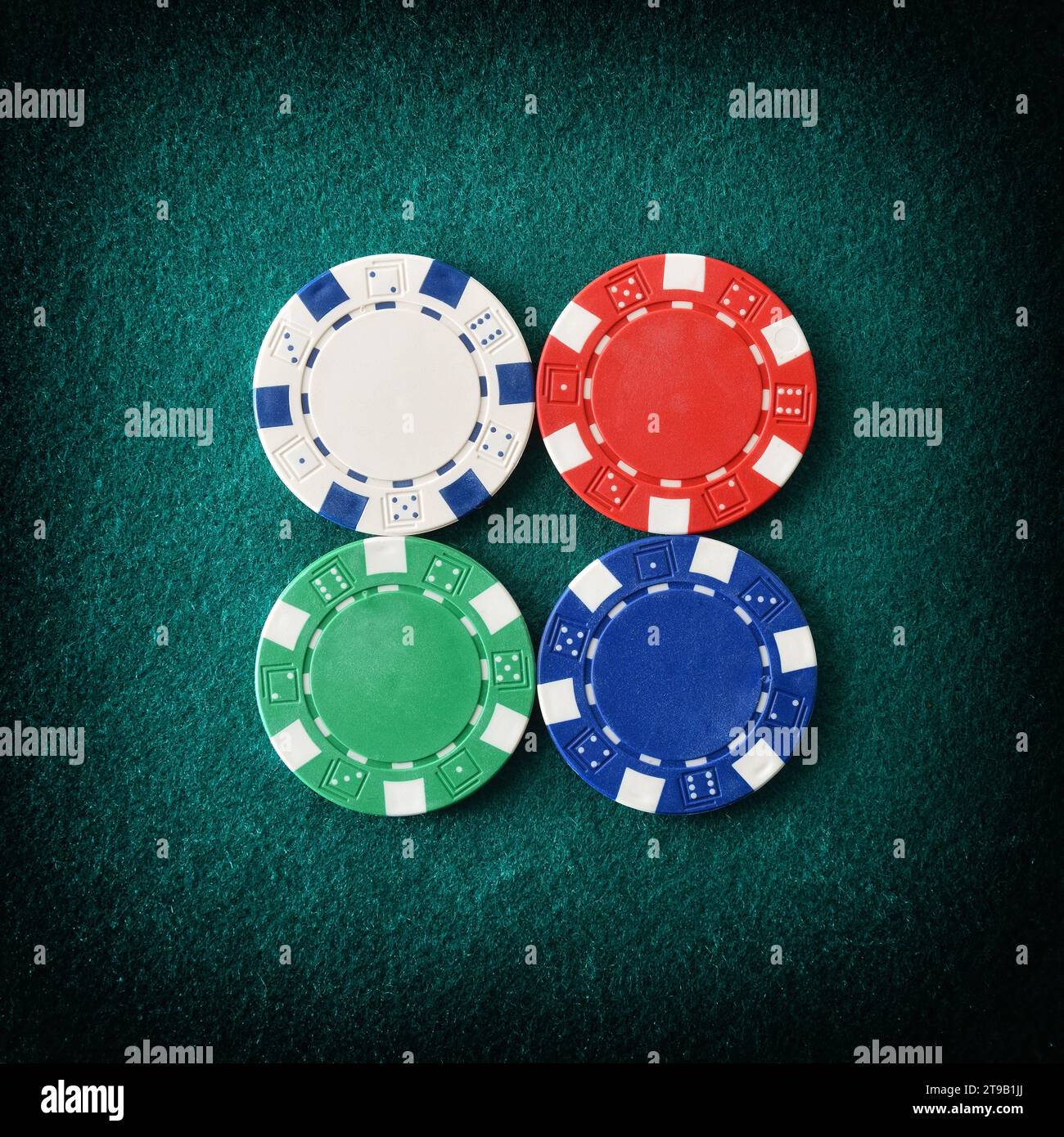 Casino background with detail of four different colored plastic chips ...