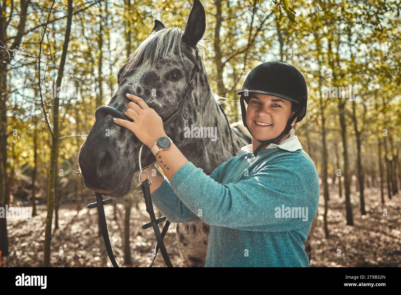 Portrait of woman with horse in forest, smile and pride for competition ...