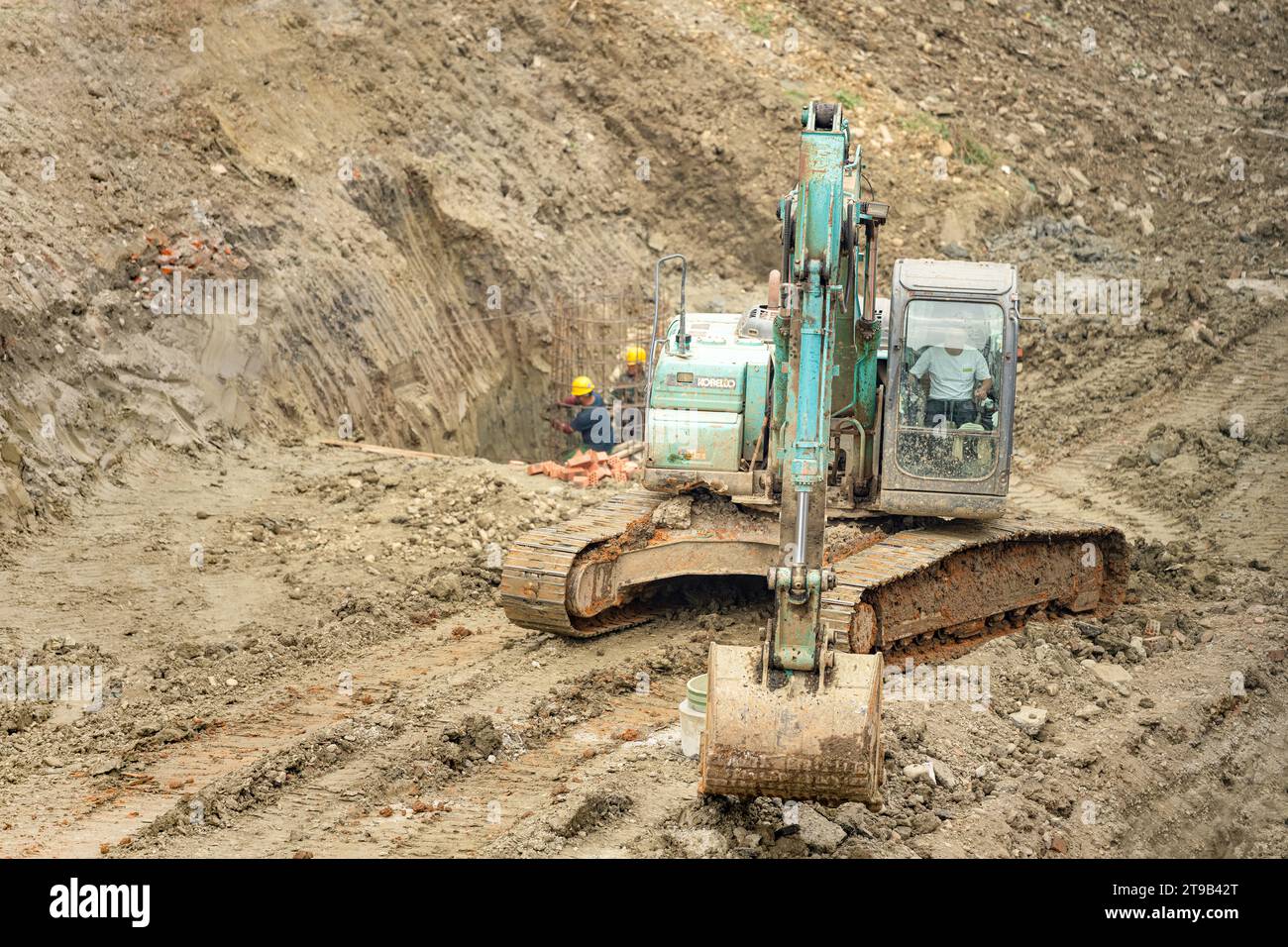 Excavator digging soil in the construction site Stock Photo - Alamy Excavator digging soil in the construction site Stock Photo - Alamy