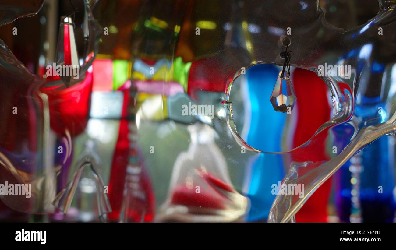 A curved piece of plexiglass with crystal drops in it. The background ...