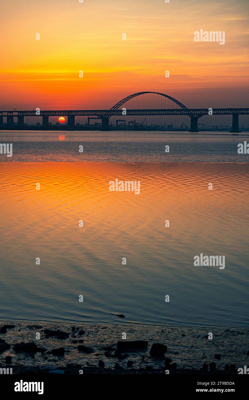 sunrise on Changjiang/ Yangtze River through a steel bridge Stock Photo ...