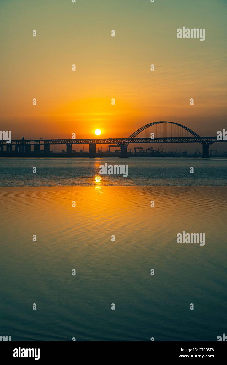 sunrise on Changjiang/ Yangtze River through a steel bridge Stock Photo ...