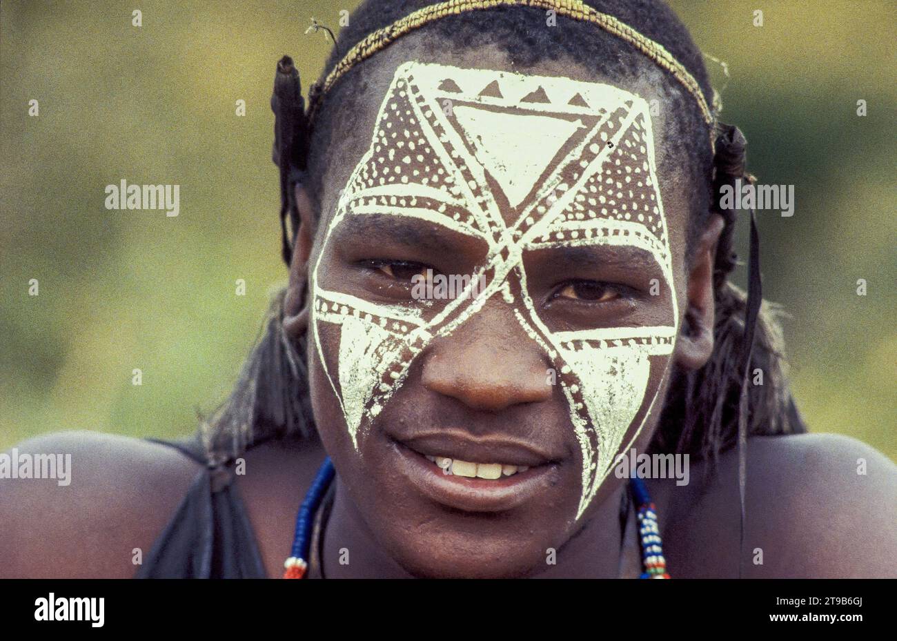 Tanzania, Portrait of a Maasai boy with white painted face, ready for ...