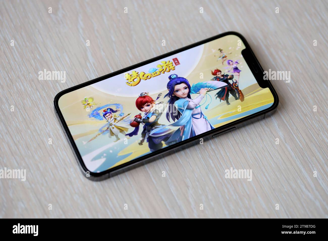 Fantasy Westward Journey mobile iOS game on iPhone 15 smartphone screen ...