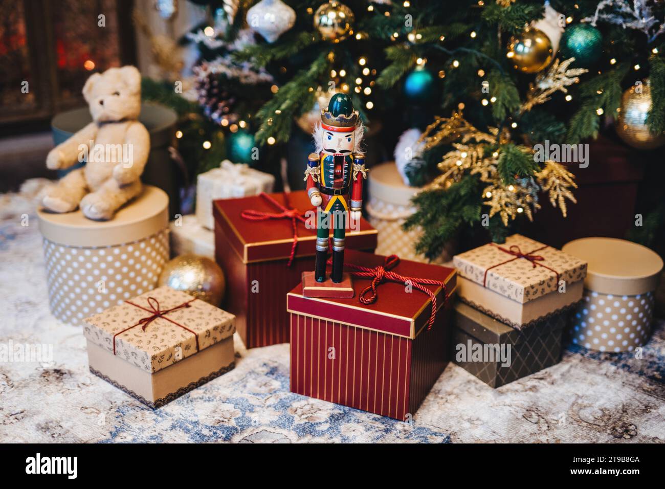 Nutcracker soldier stands guard among wrapped Christmas gifts and a ...