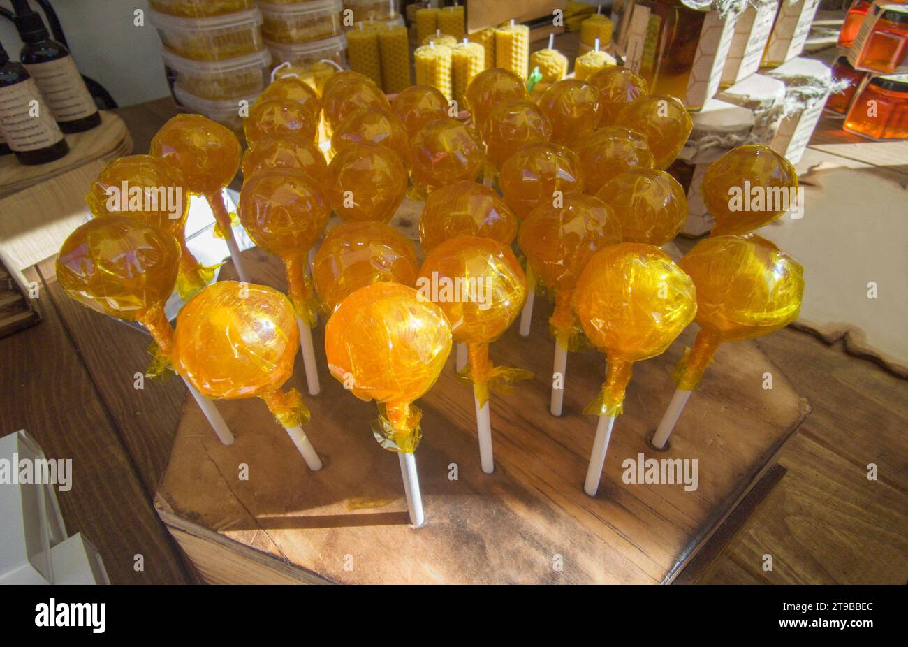 Honey lollipops displayed in a traditional market stall. Healthy candy ...
