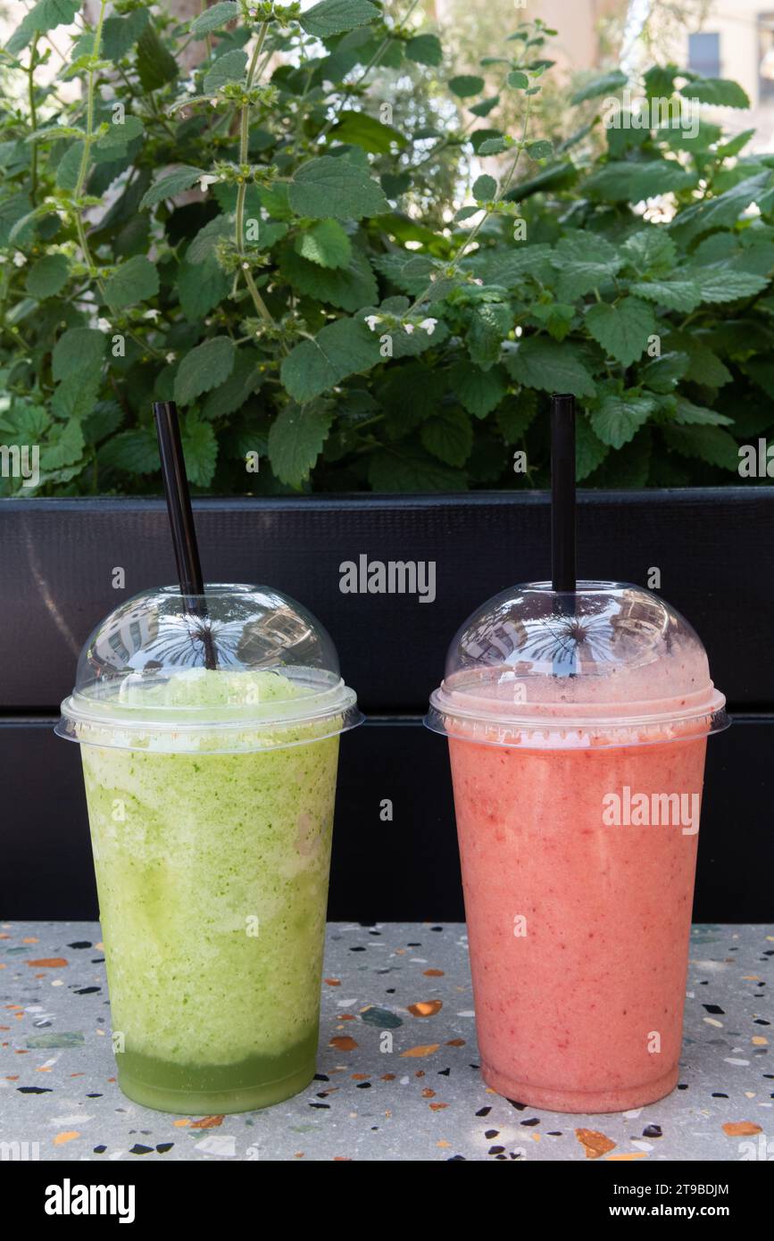 Two plastic cups with mouth-watering, freshly squeezed lemon-mint and ...