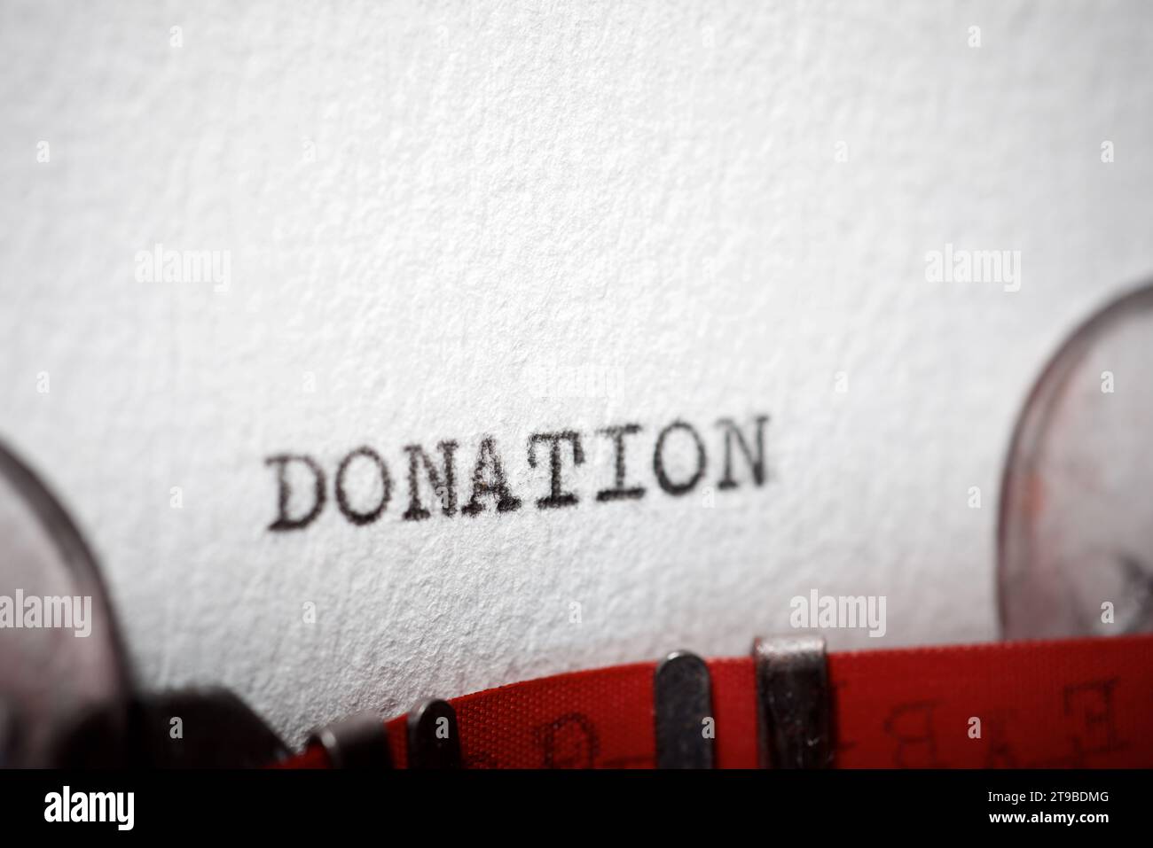 Donation word written with a typewriter Stock Photo - Alamy