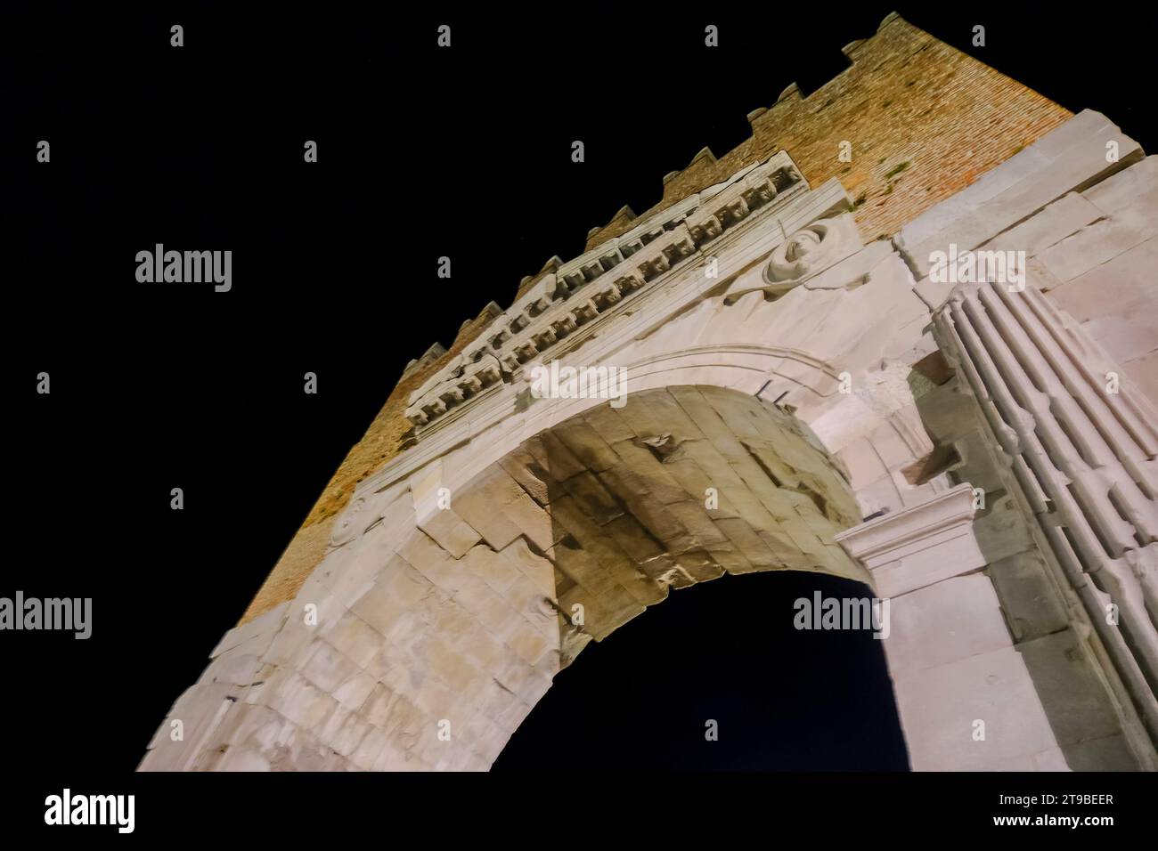 Arch of Augustus from beneath in the night, a gate in the former city ...