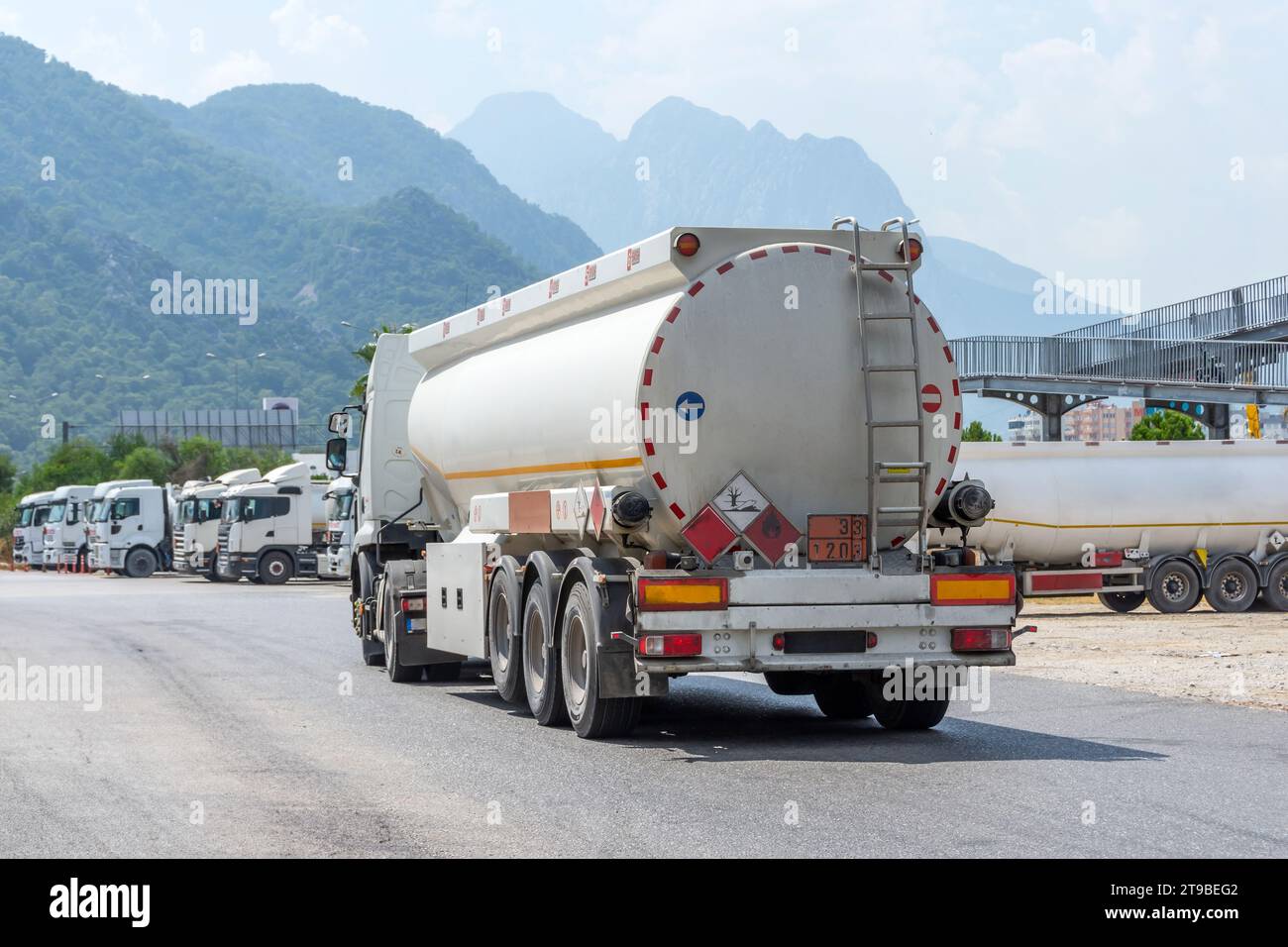 Parking row of trucks with fuel tanks in front of a warehouse and ...