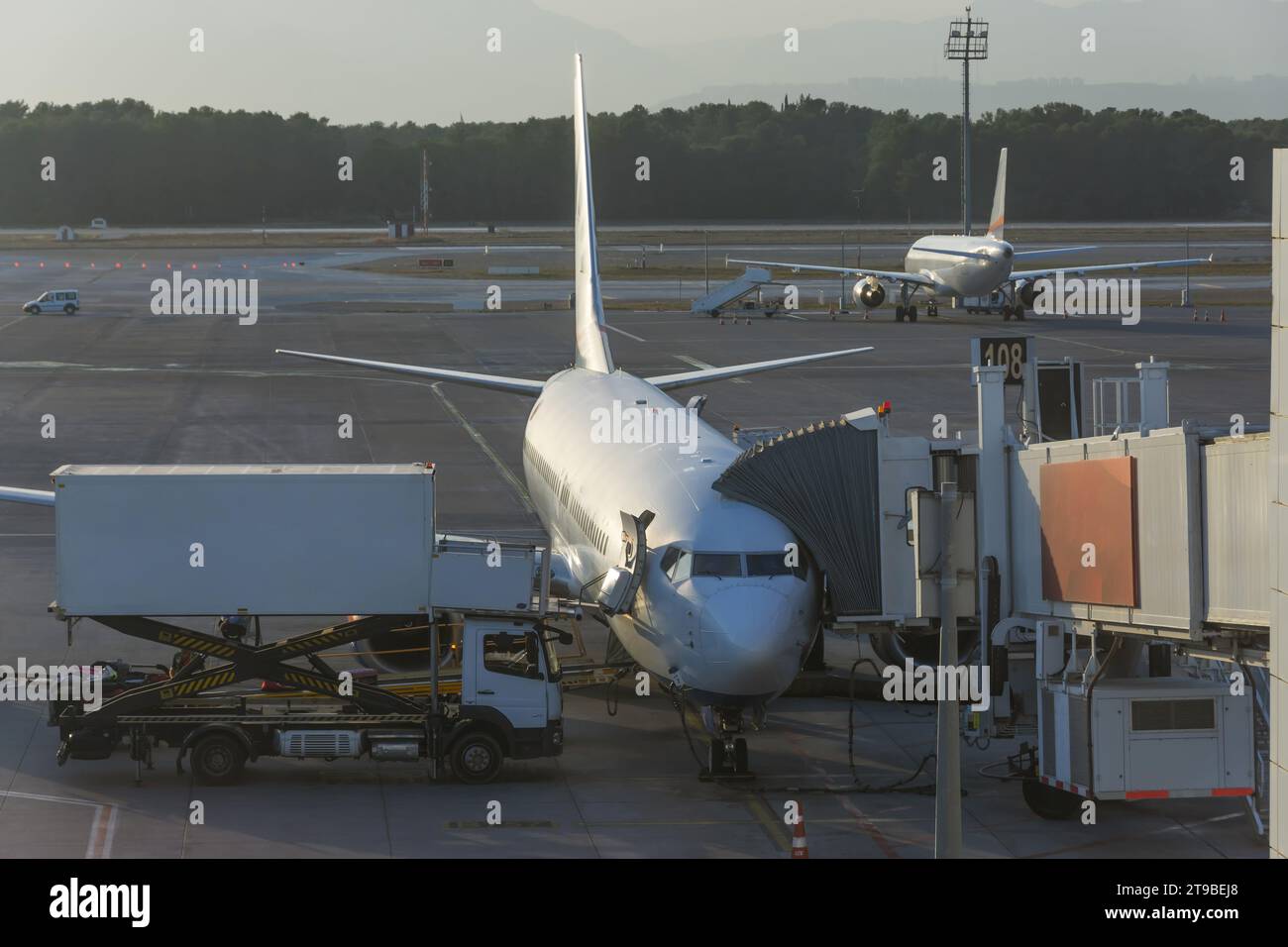 View of the nose and cockpit of the aircraft and the docking gangway ...