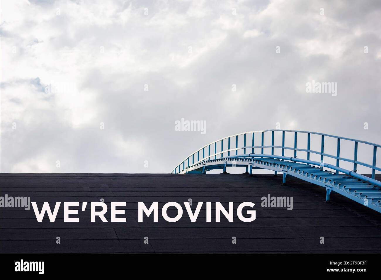 On a black background with the text WE ARE MOVING. business concept ...