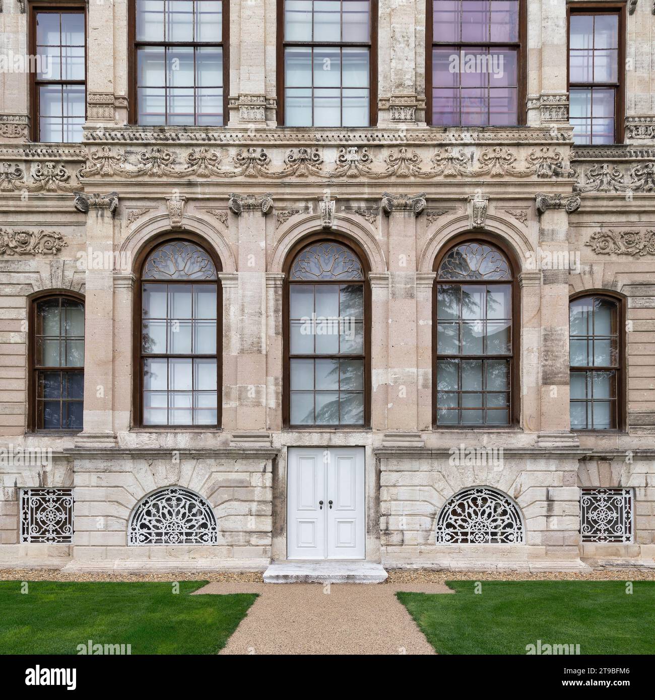 Side wall at Dolmabahce Palace, with small wooden door and arched ...