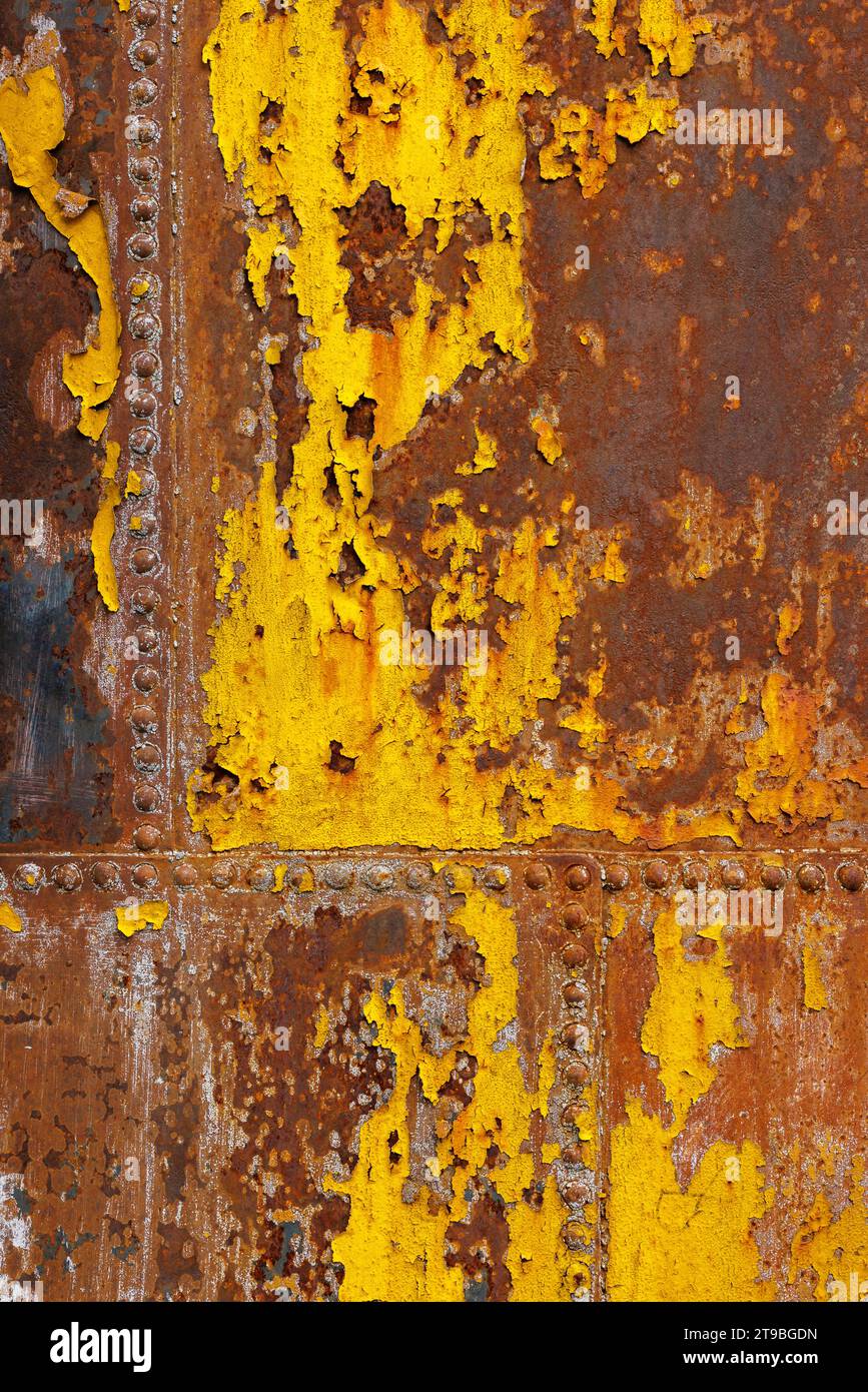 beautifully rusted rivetted sheet metal with leftovers of yellow paint ...