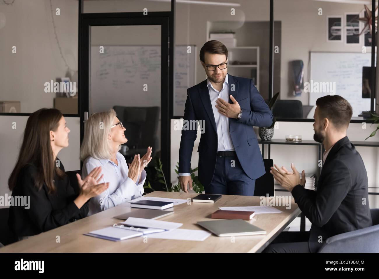 Employees applauding successful speaker, coach, colleague after ...