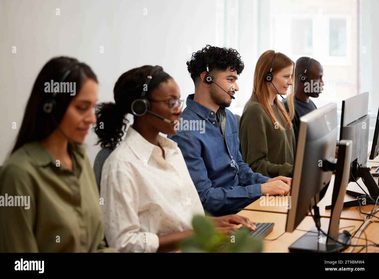 Diverse call center employees at work Stock Photo - Alamy