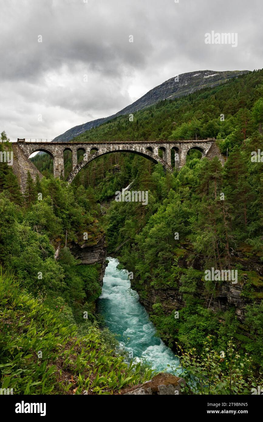 View of arch bridge over valley with flowing river Stock Photo - Alamy