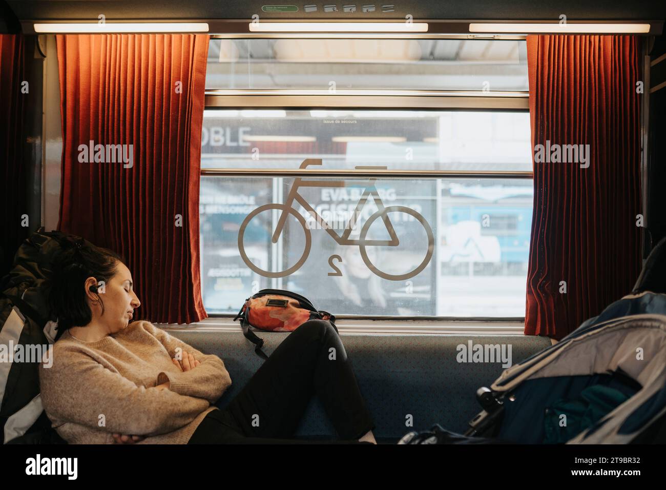 Young woman sleeping in train Stock Photo - Alamy