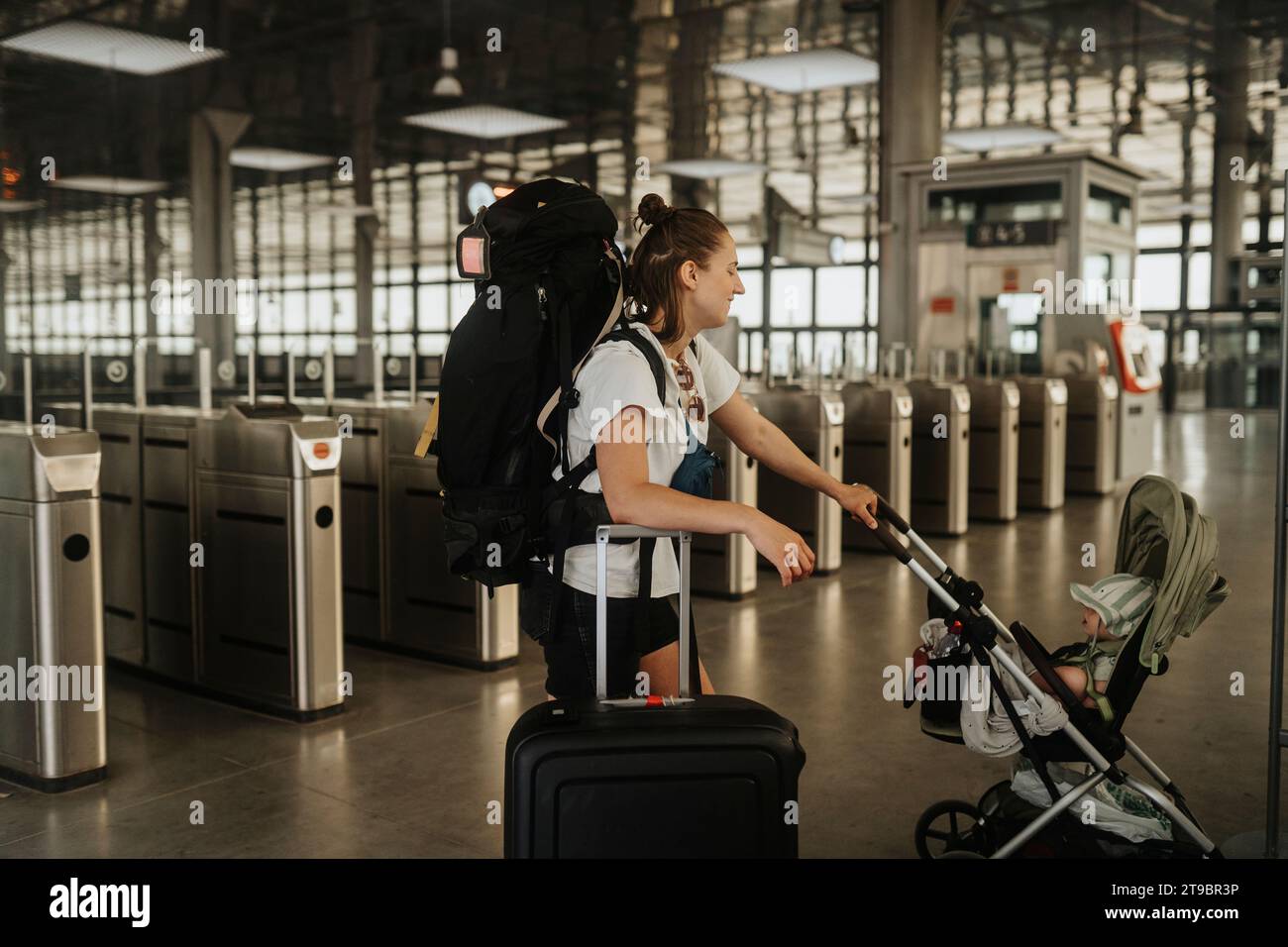 Mother with baby in stroller at train station Stock Photo - Alamy
