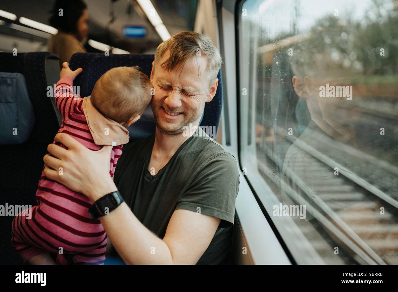 Father traveling with baby by train Stock Photo - Alamy