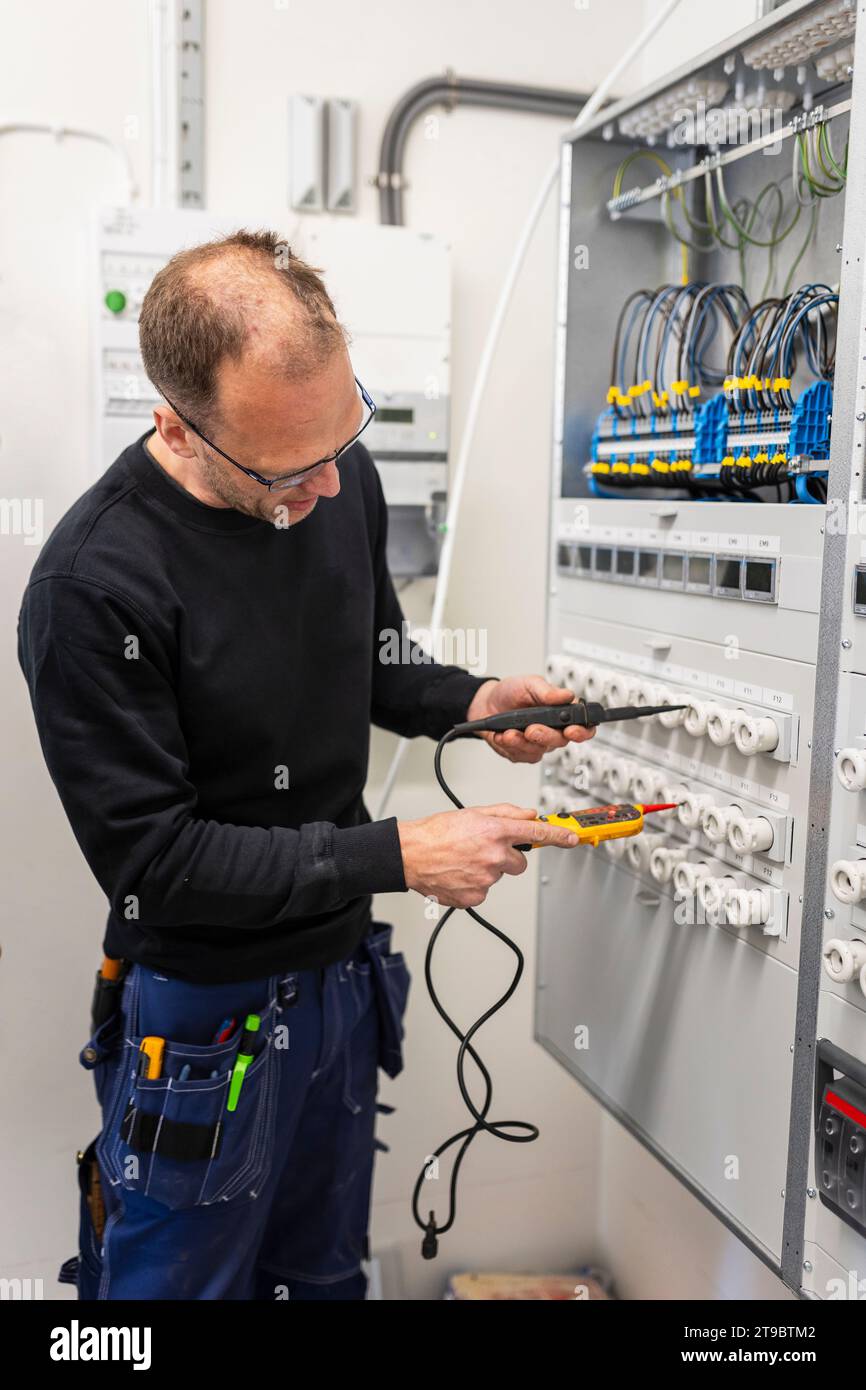 Repairman repairing meter box while working in industry Stock Photo - Alamy