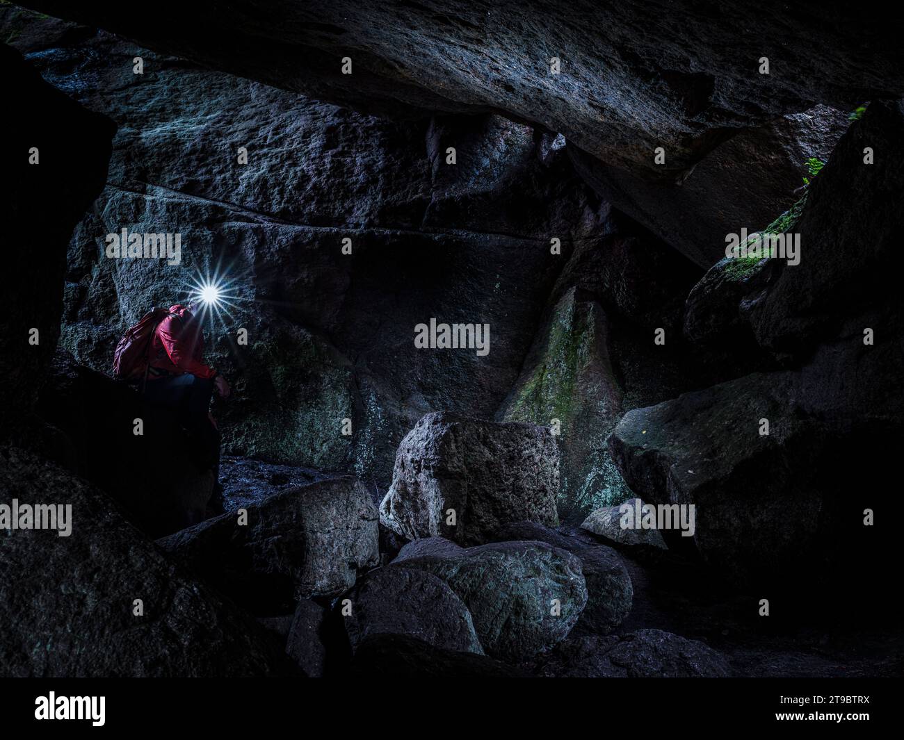 Tourist with headlamp exploring cave Stock Photo - Alamy