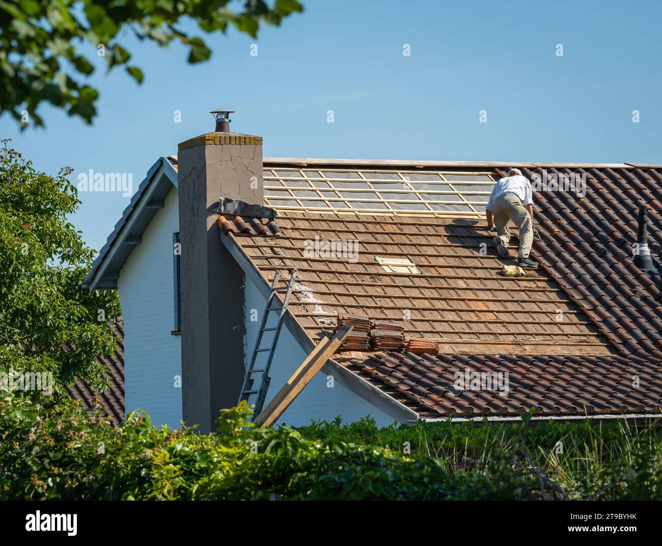 Handyman repairing the roof, roofing and roof tiles replacement Stock Photo - Alamy