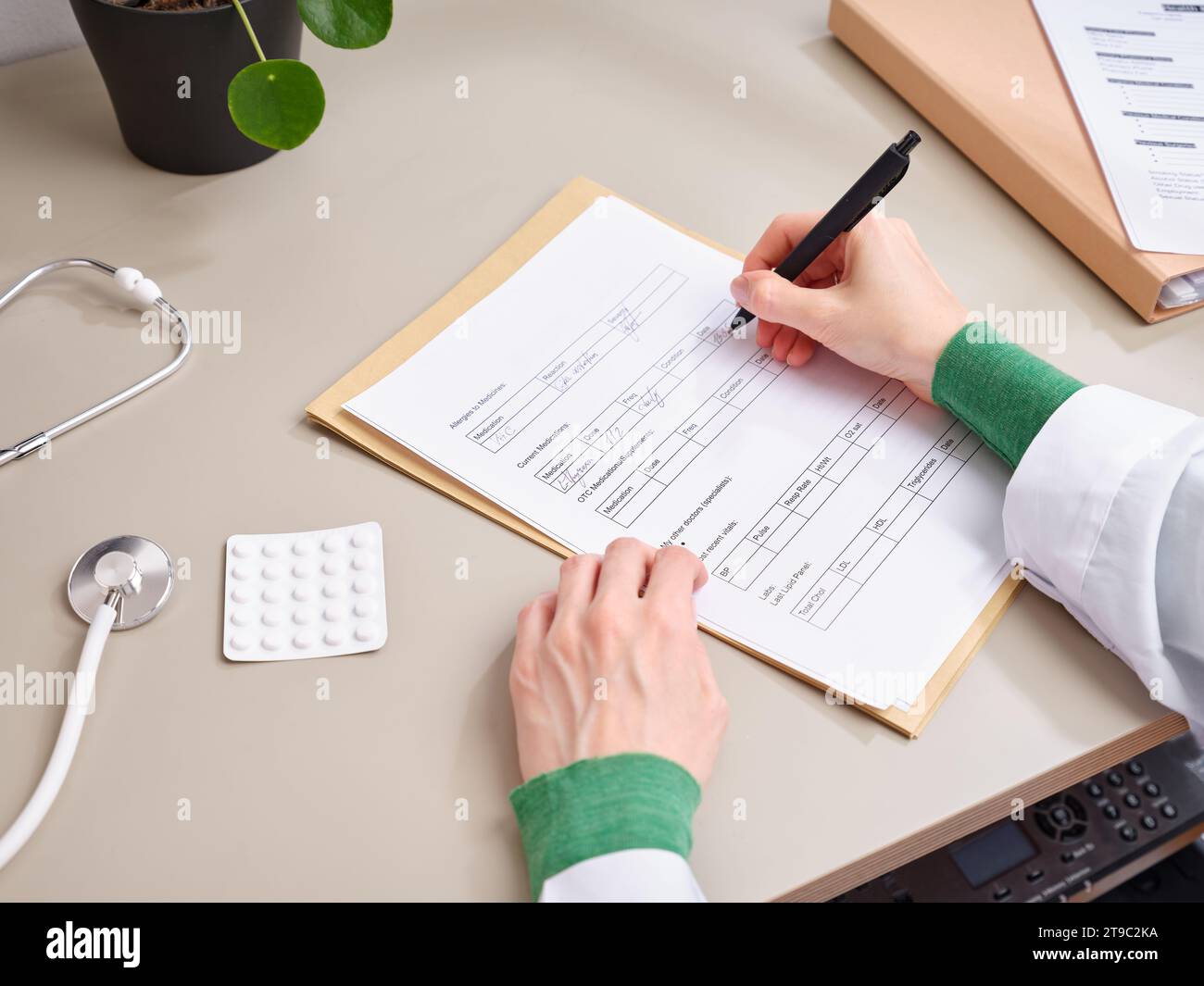 Top view unrecognisable doctor taking notes in medical documentation at ... Top view unrecognisable doctor taking notes in medical documentation at ...