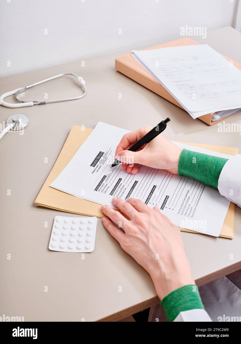 Top view unrecognisable doctor taking notes in medical documentation at ... Top view unrecognisable doctor taking notes in medical documentation at ...