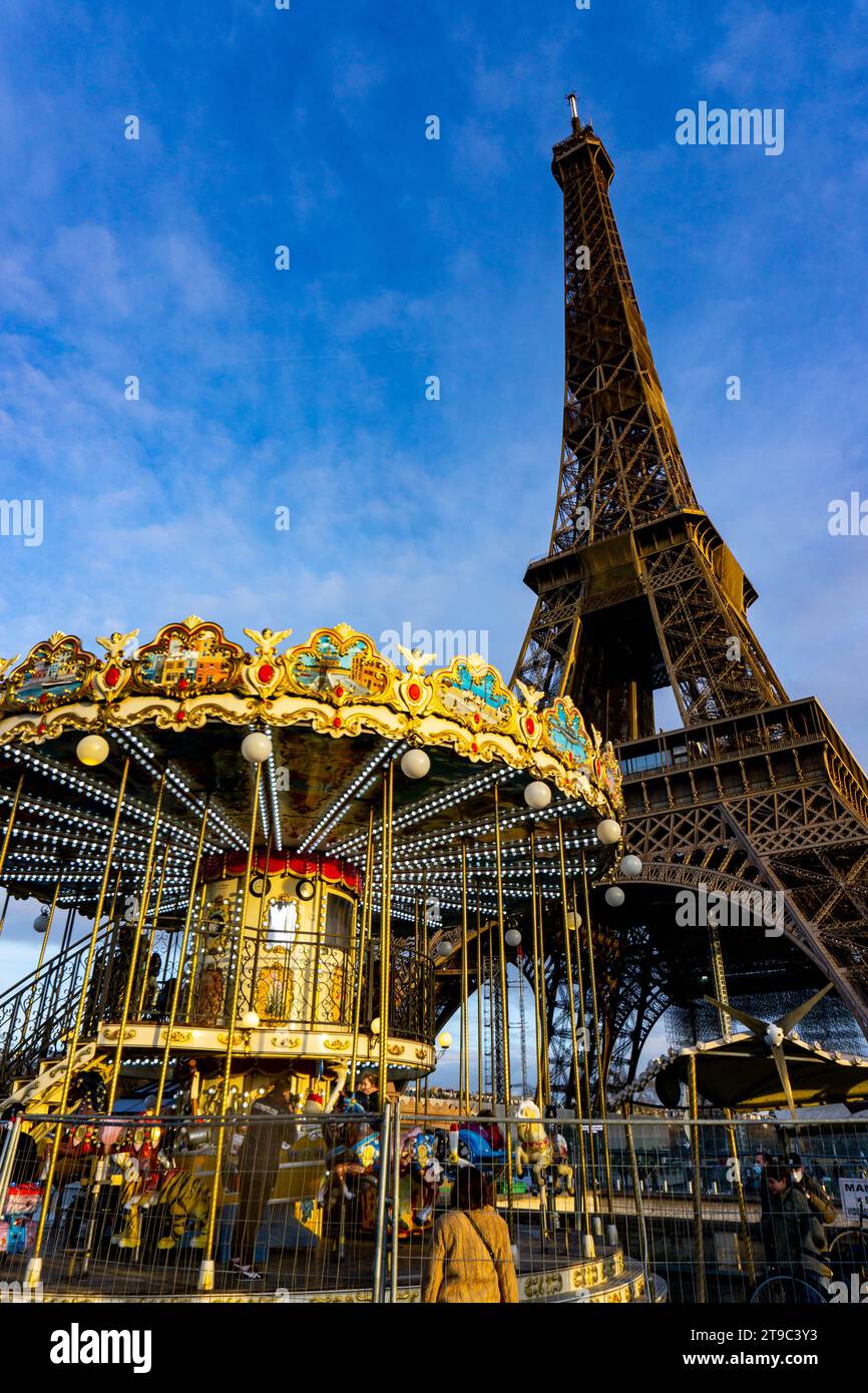A golden carousel spins against a backdrop of the Eiffel Tower and a ...