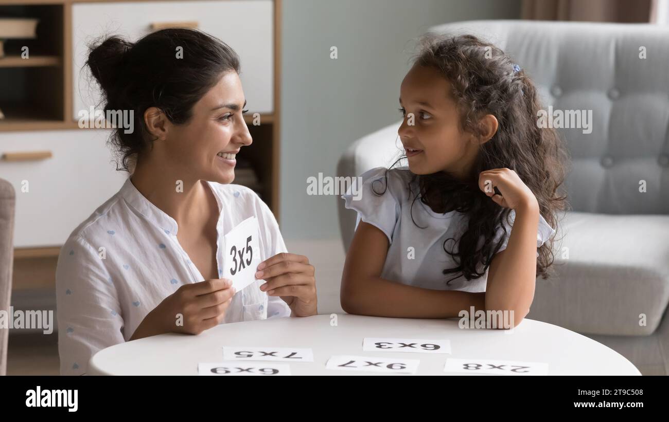 Loving Indian mother check daughters knowledge in multiplication at ...