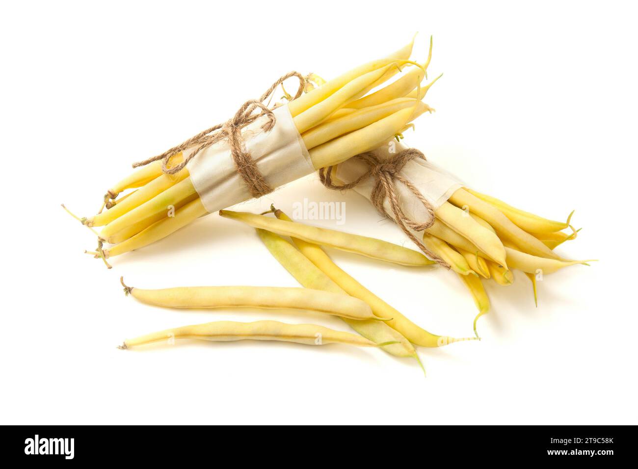 Two bunches and small pile of raw yellow pods of haricot isolated on ...
