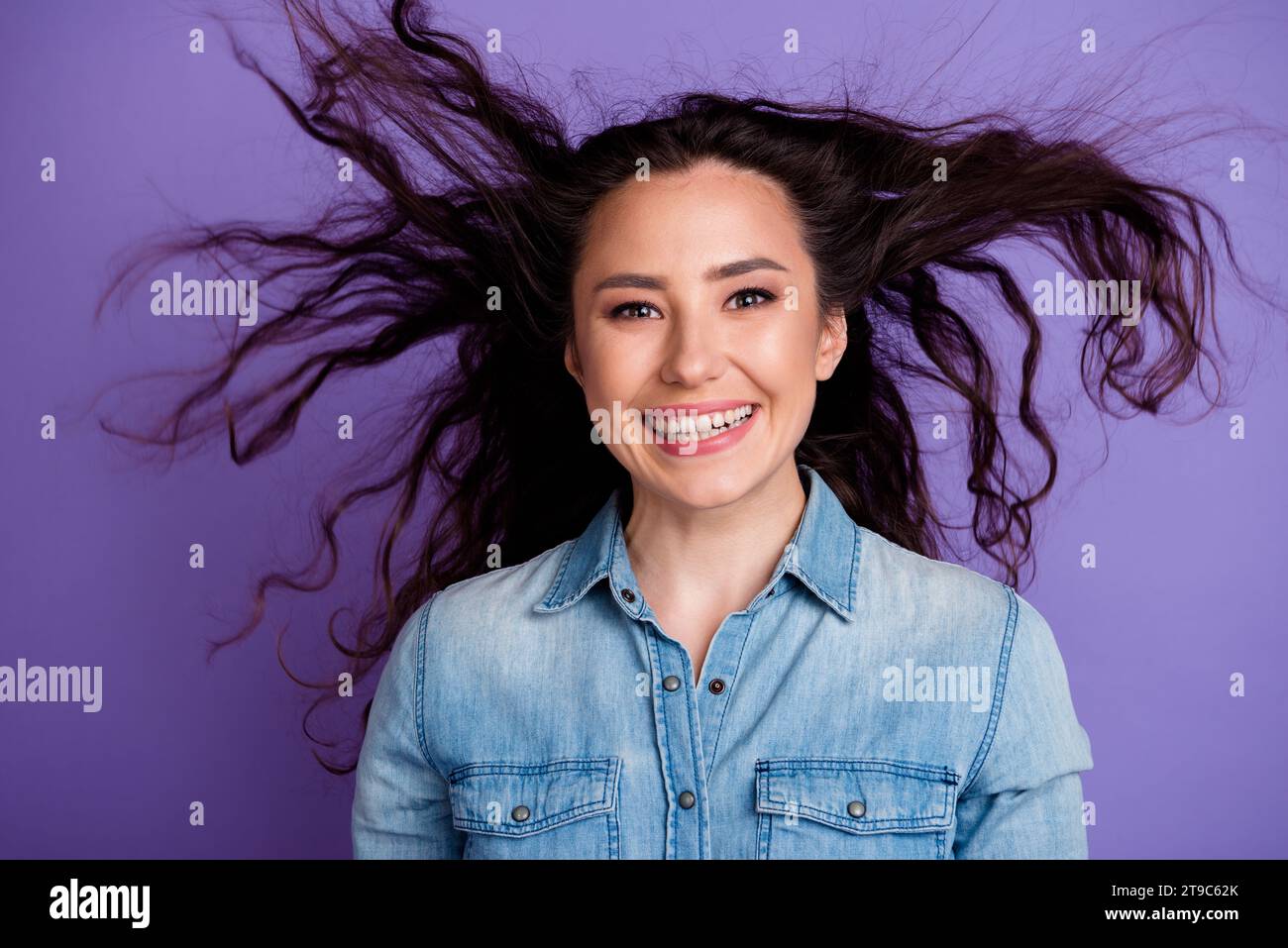 Portrait of overjoyed crazy girl beaming smile flying messy hair ...