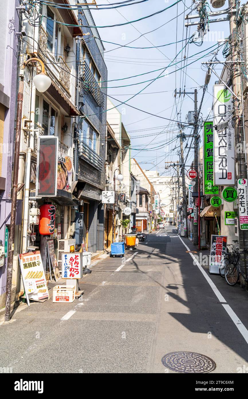 Typical narrow Japanese town city street with no pavement, and single ...