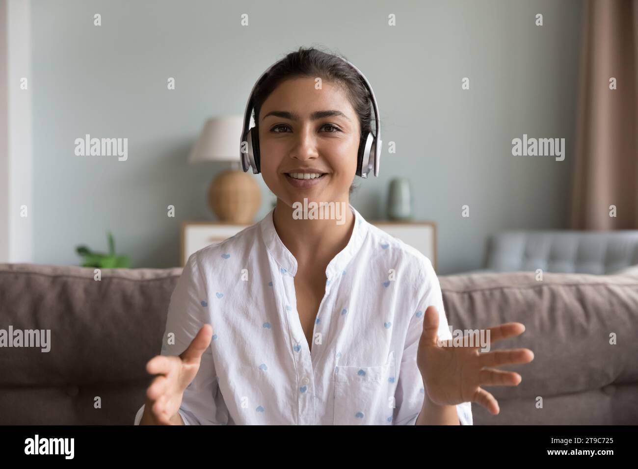 Indian woman wear headphones talk to camera, webcam view Stock Photo ...
