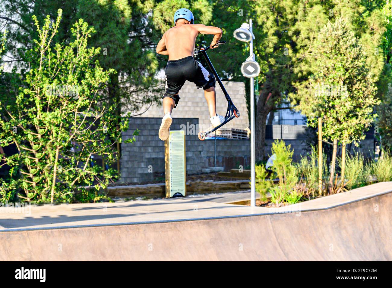 Young man practicing Scootering (Freestyle Scootering) in the new ...