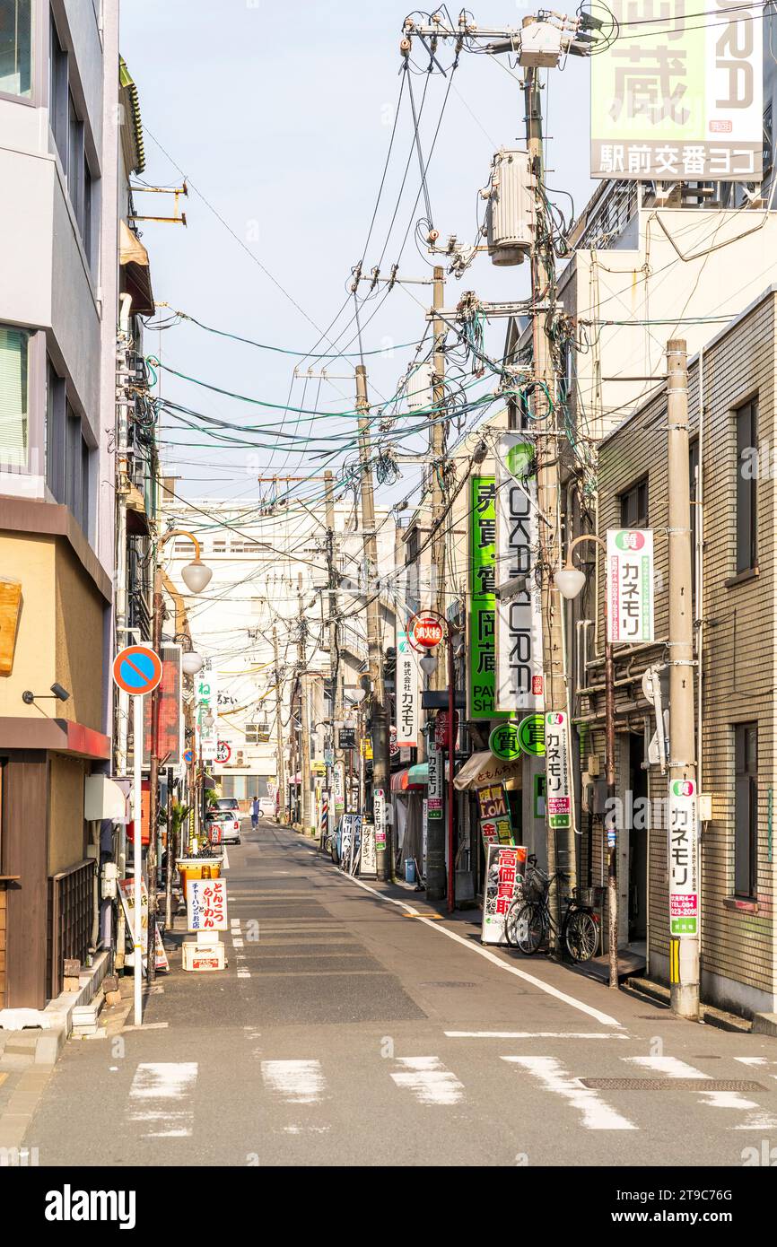 Typical narrow Japanese town city street with no pavement, and single ...