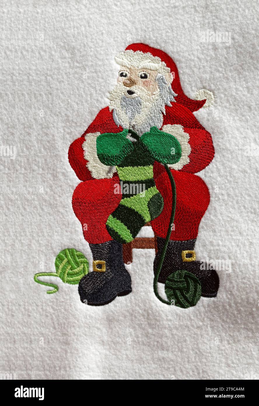 Santa Claus doing crochet, making striped stocking, ball of yarn ...