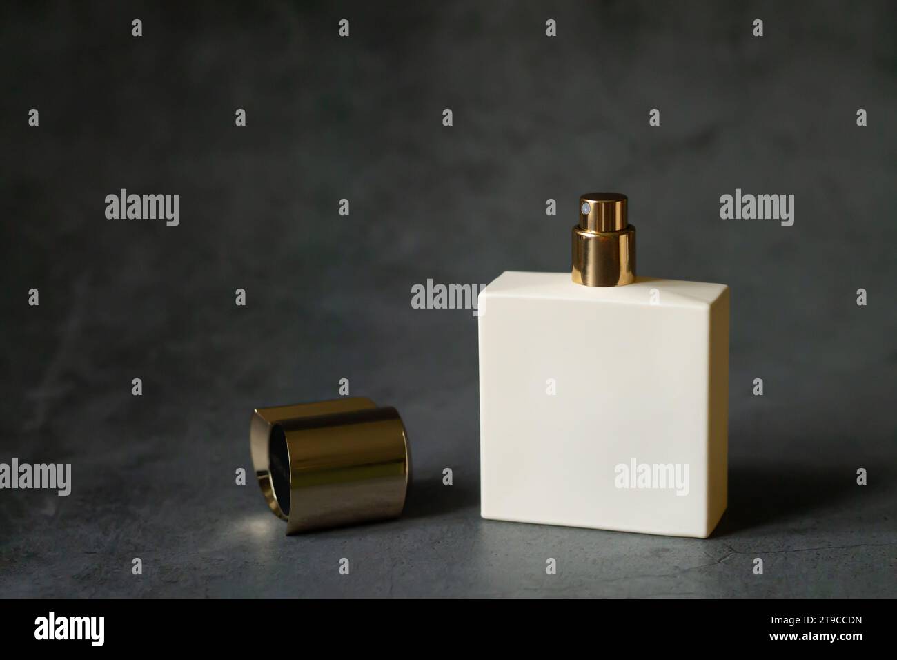 Open perfume square bottle mockup on dark stone table Stock Photo - Alamy