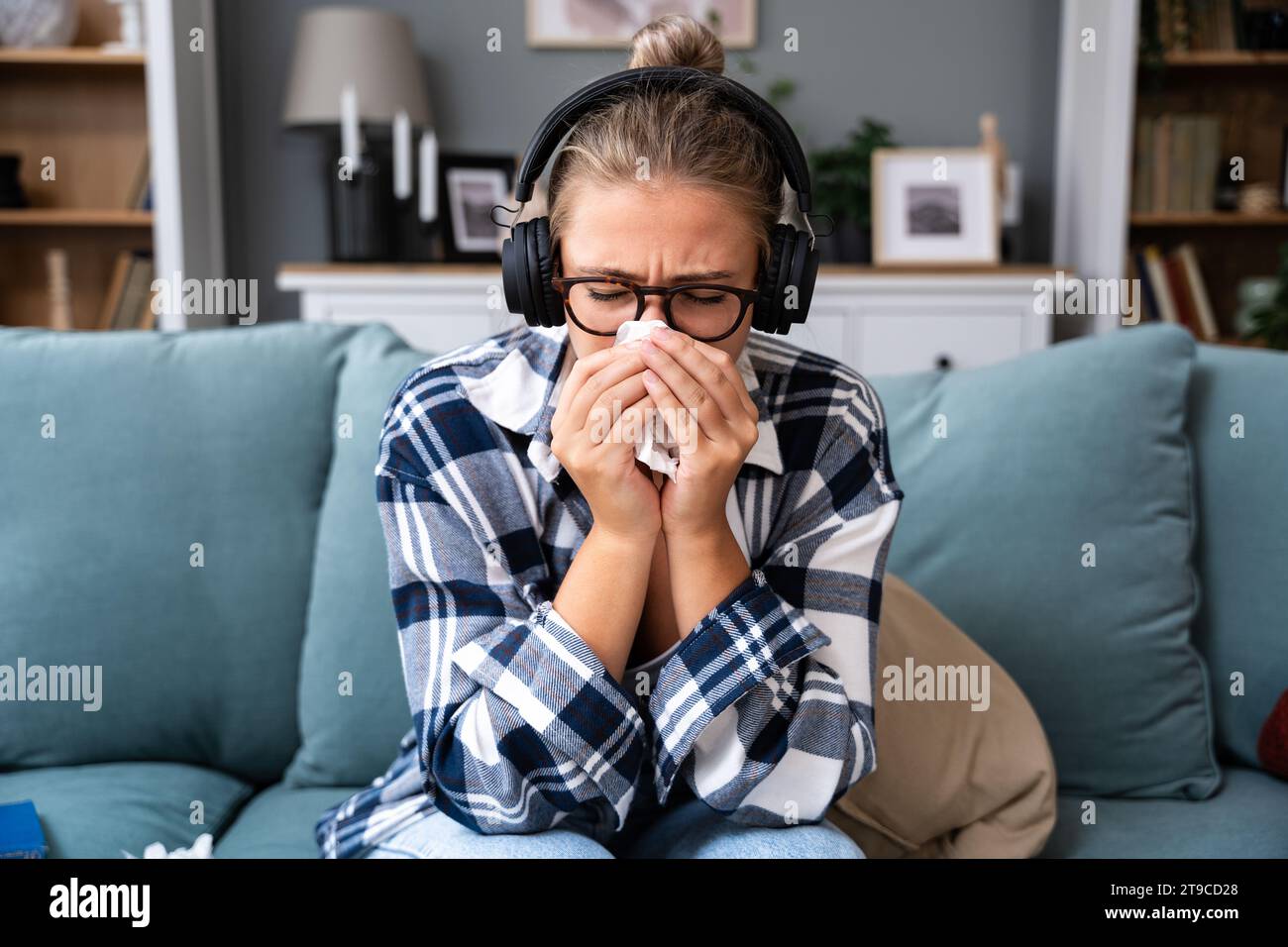 Sad tired young woman touching forehead having headache migraine or ...